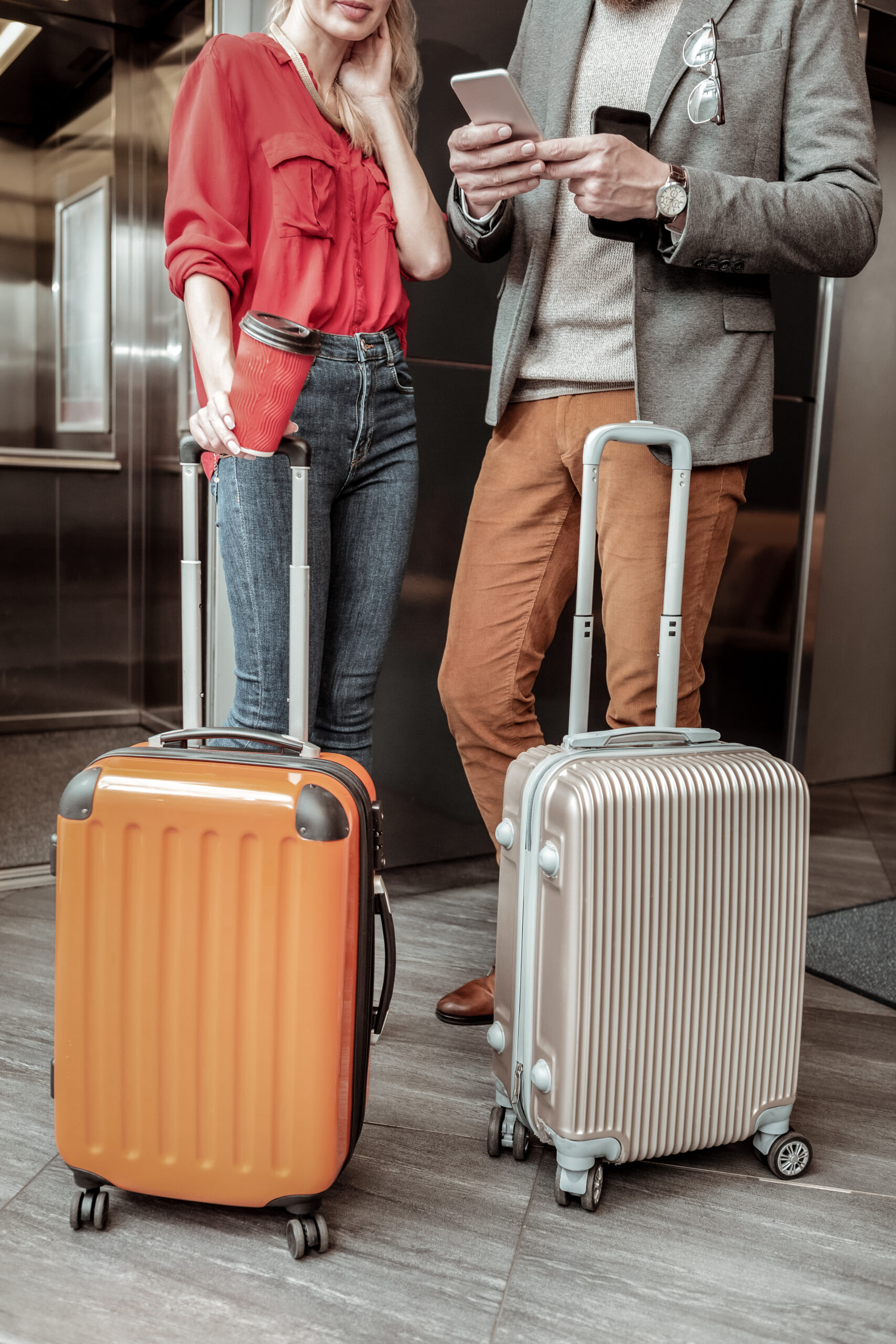 Modern partners standing together near their luggage - Newlyweds on a ...